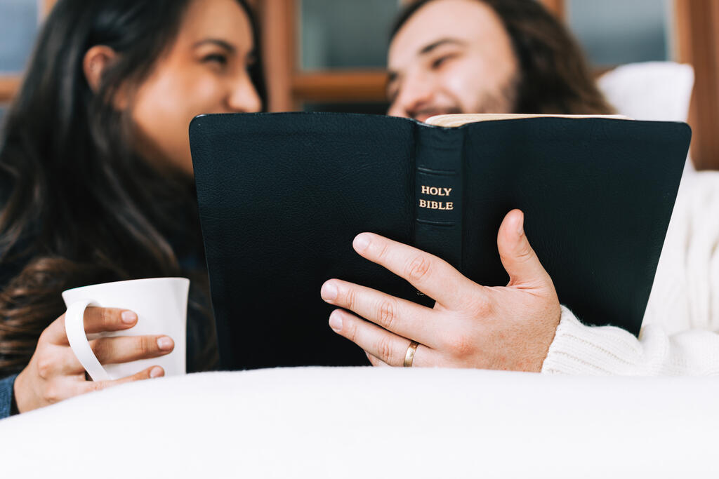 Husband And Wife Reading The Bible Together In Bed Graphics For The