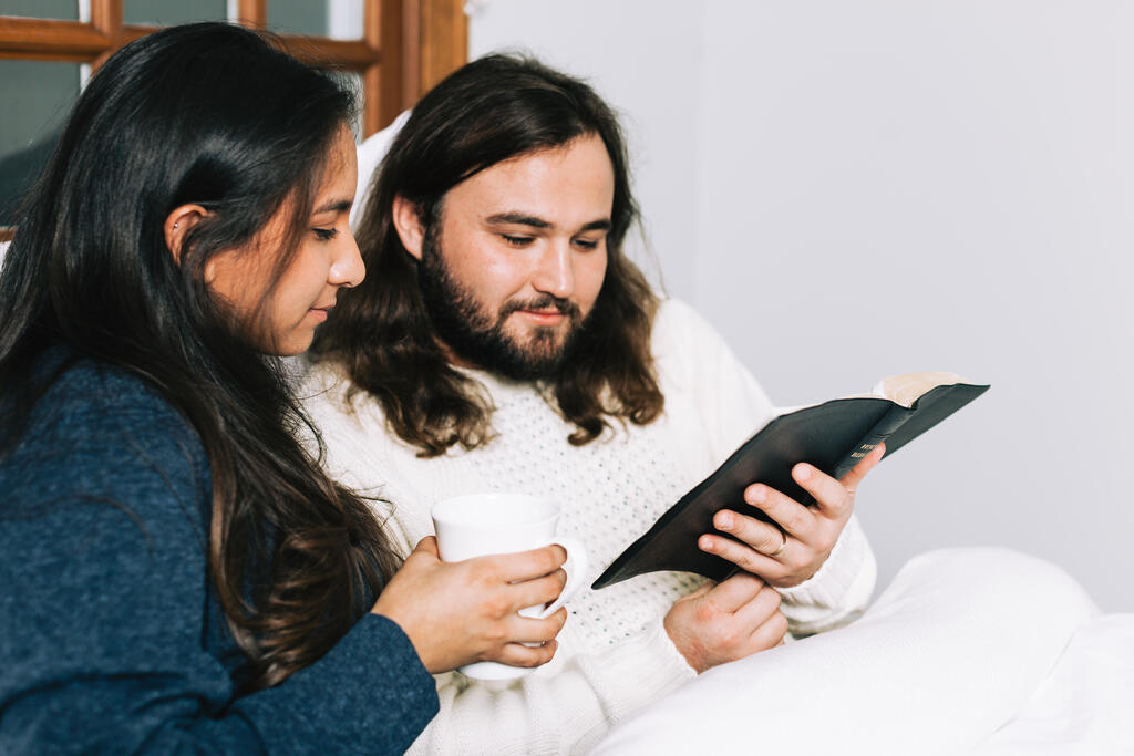 Husband And Wife Reading The Bible Together In Bed Graphics For The